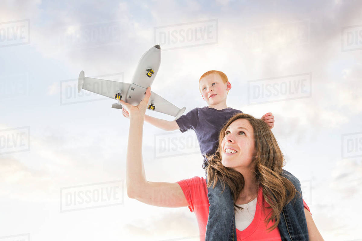 Caucasian mother and son flying toy airplane - Royalty-free Stock Photo ...