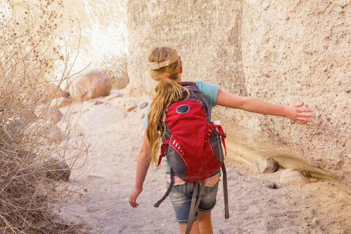 Caucasian girl touching rock formation - Royalty-free Stock Photo ...