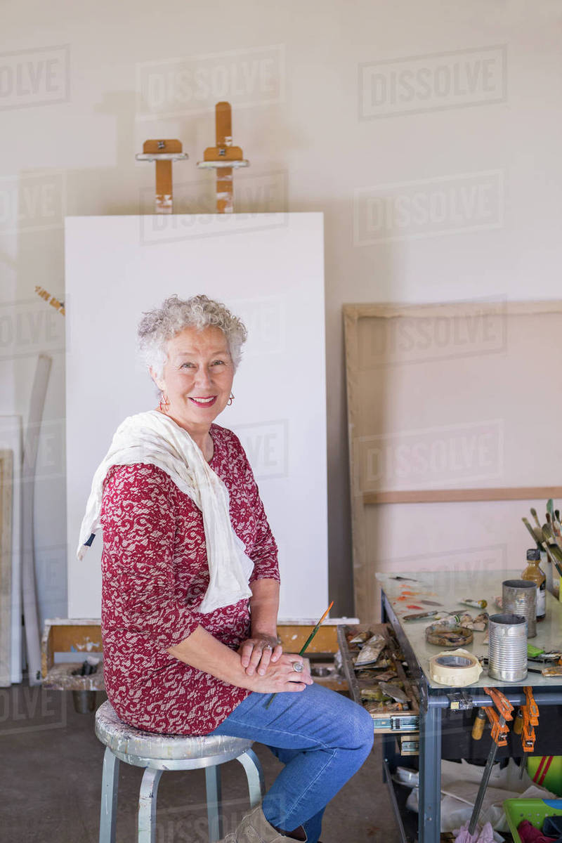 Artist smiling in studio - Royalty-free Stock Photo | Dissolve