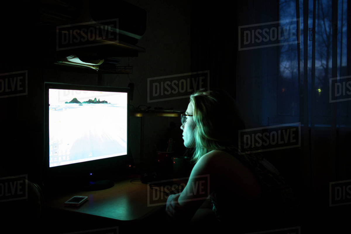 Caucasian woman using computer at night - Royalty-free Stock Photo ...