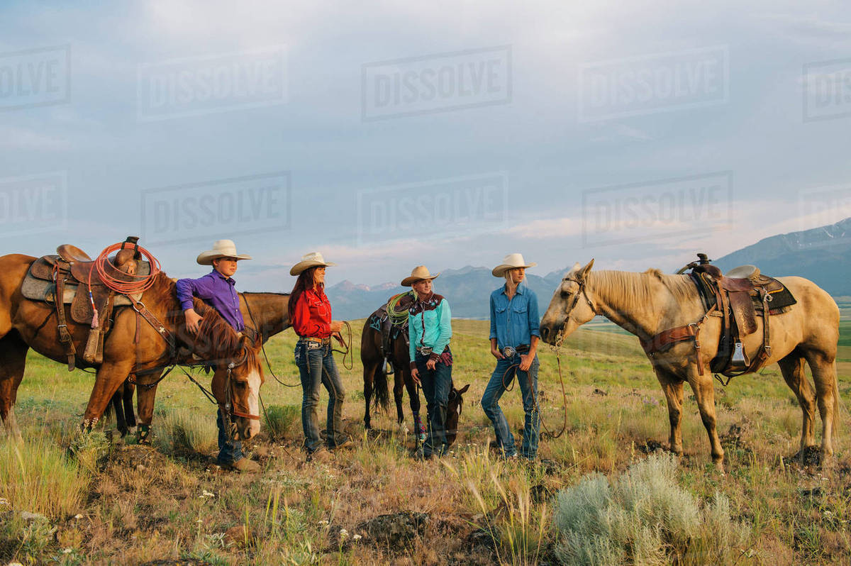 Cowboy and cowgirls with horses on ranch - Royalty-free Stock Photo ...