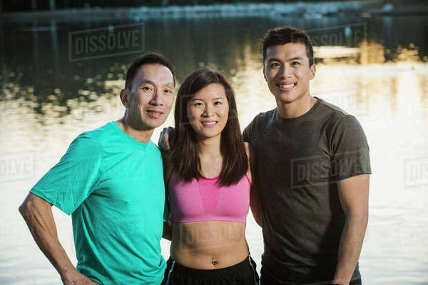 Chinese friends smiling in park - Royalty-free Stock Photo | Dissolve