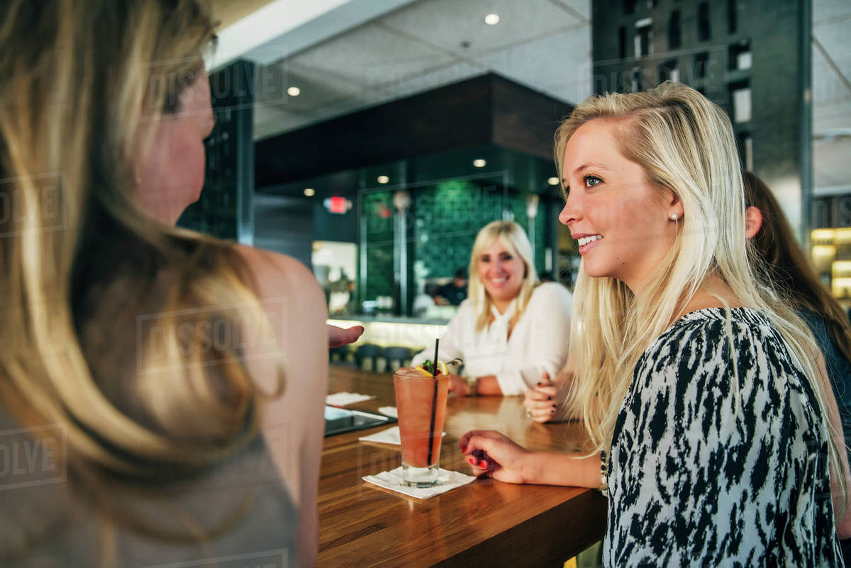 Caucasian women sitting at bar with cocktails - Royalty-free Stock ...