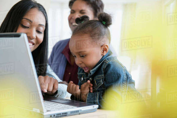 Black multi-generation family using laptop - Stock Photo - Dissolve