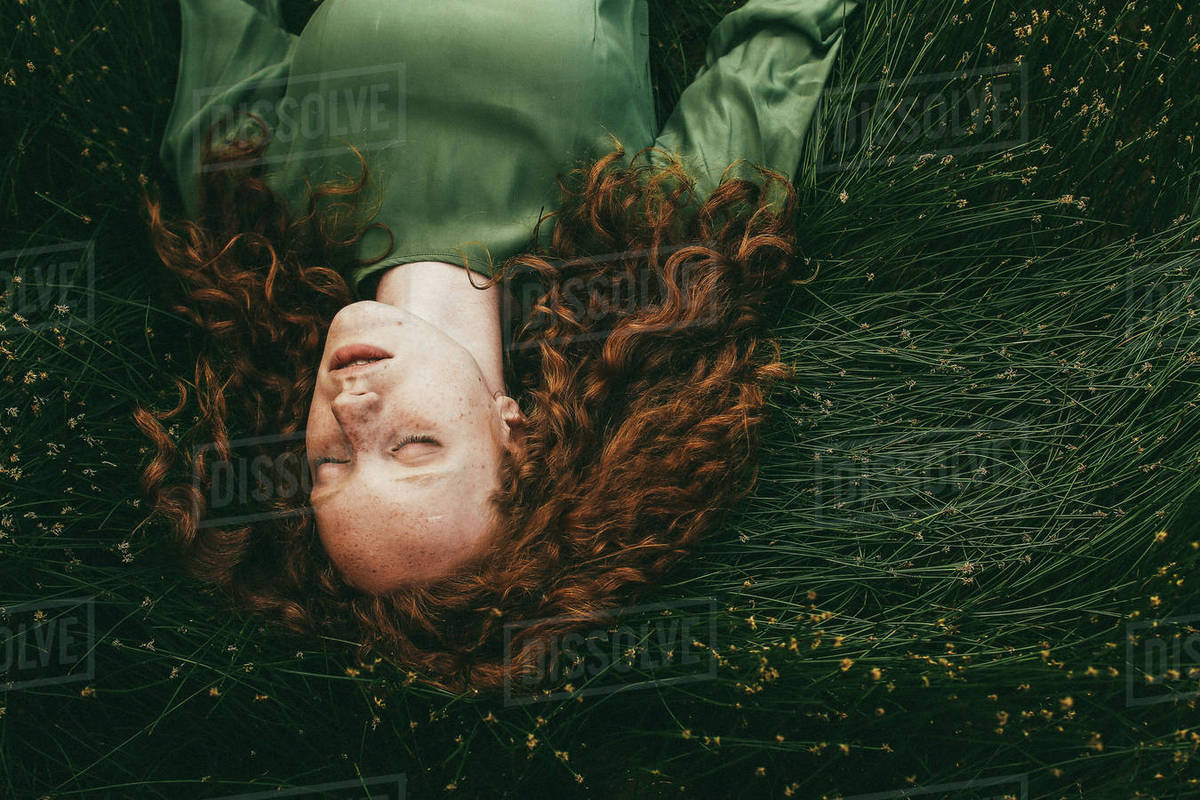 Caucasian girl sleeping in grass - Royalty-free Stock Photo | Dissolve