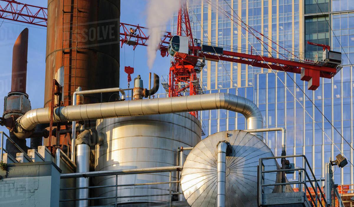 Steam from pipe near highrise - Stock Photo - Dissolve