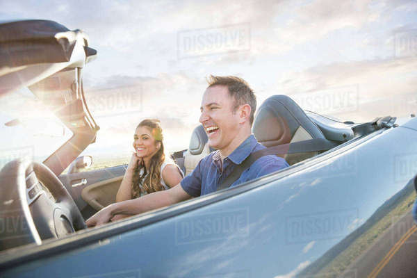 Caucasian couple driving in sports car - Royalty-free Stock Photo ...
