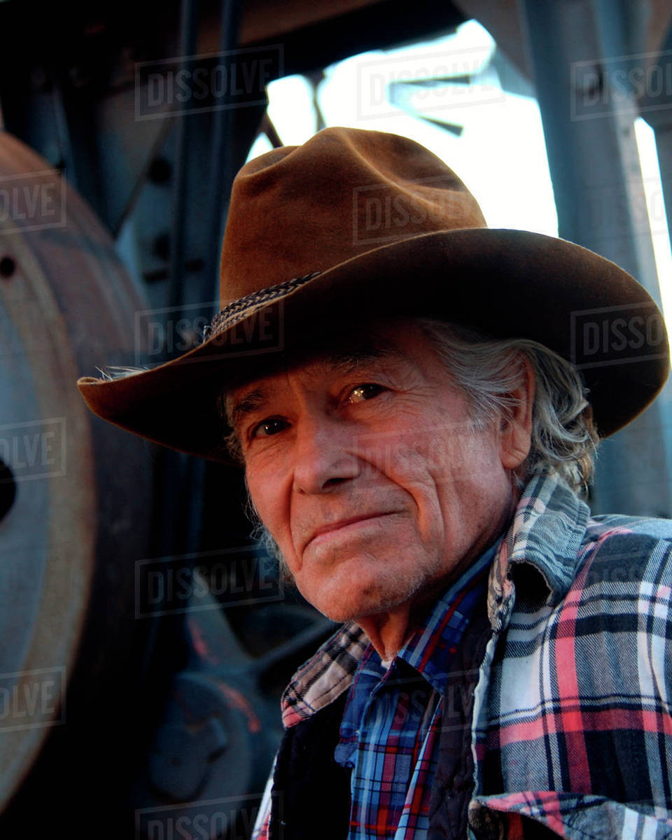 Man Wearing Cowboy Hat Looking At Camera Stock Photo Dissolve
