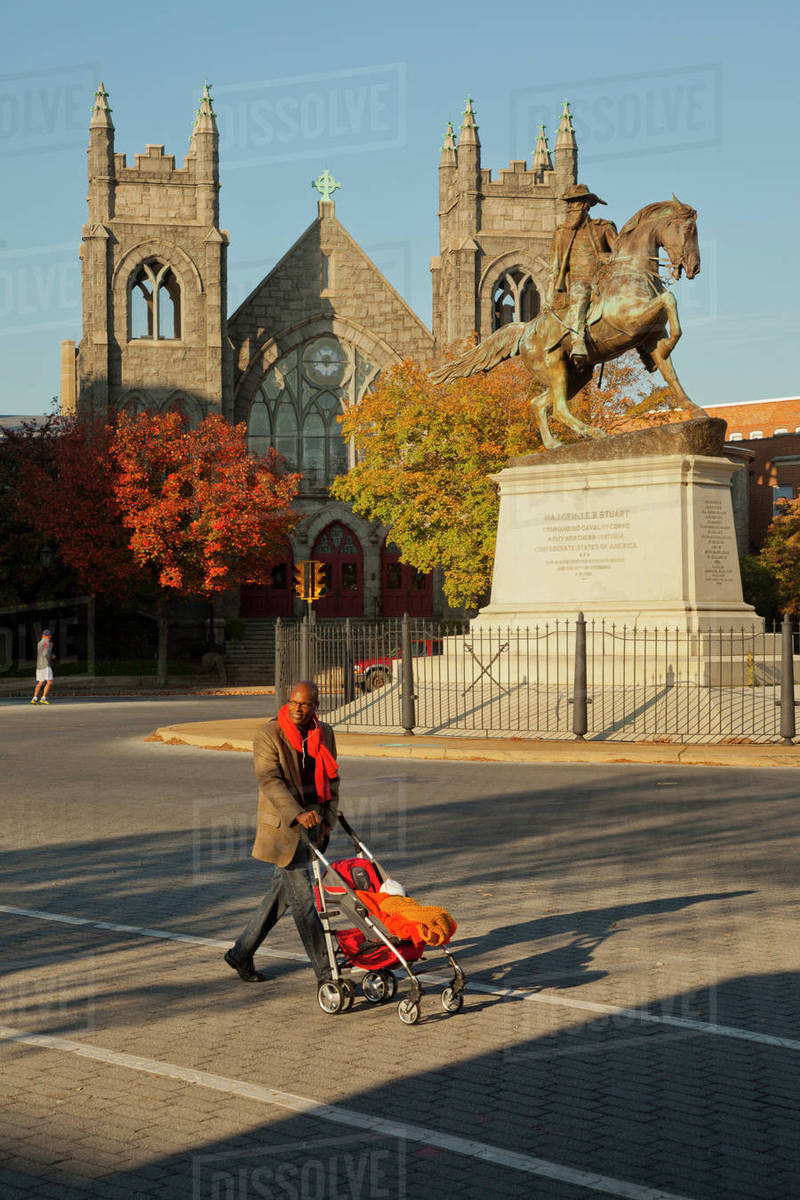 Father pushing stroller in city - Stock Photo - Dissolve
