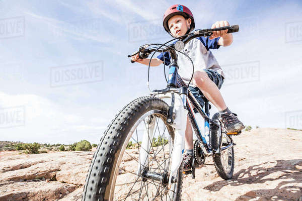 Caucasian boy riding mountain bike - Royalty-free Stock Photo | Dissolve