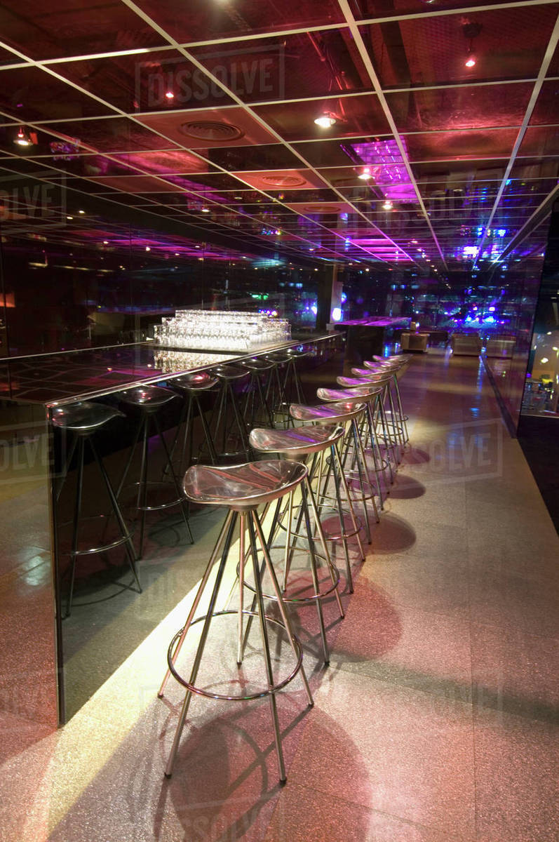 Bar counter with stools in modern nightclub - Stock Photo - Dissolve
