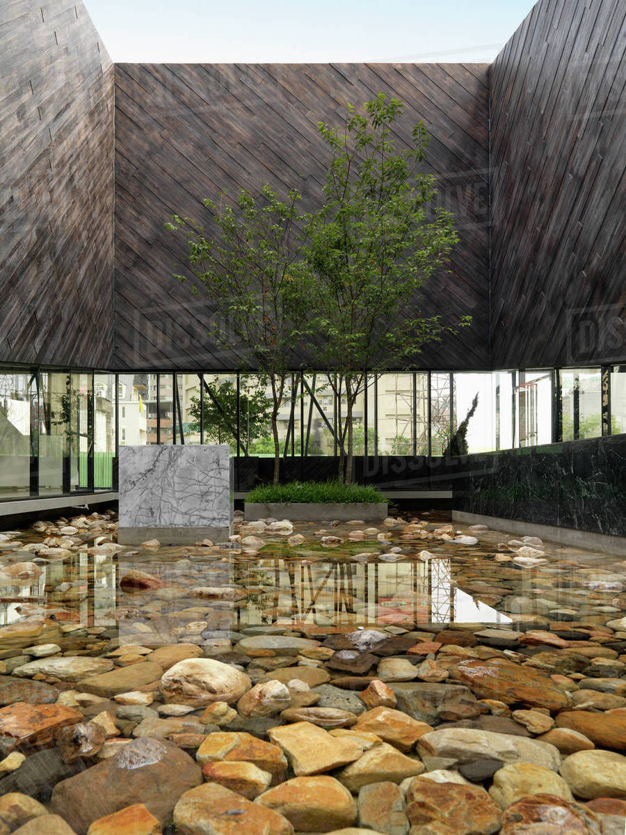 Rock pool surrounded by modern building - Stock Photo - Dissolve