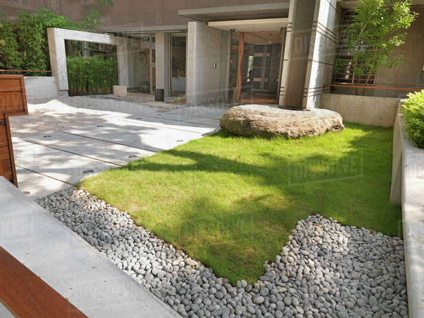 Grass and sidewalk outside front entrance of modern building - Royalty ...