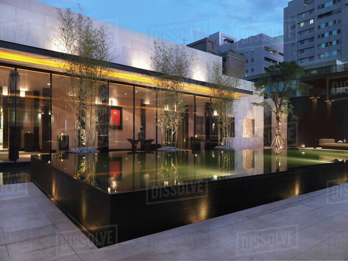 Large modern infinity pool at dusk - Royalty-free Stock Photo | Dissolve