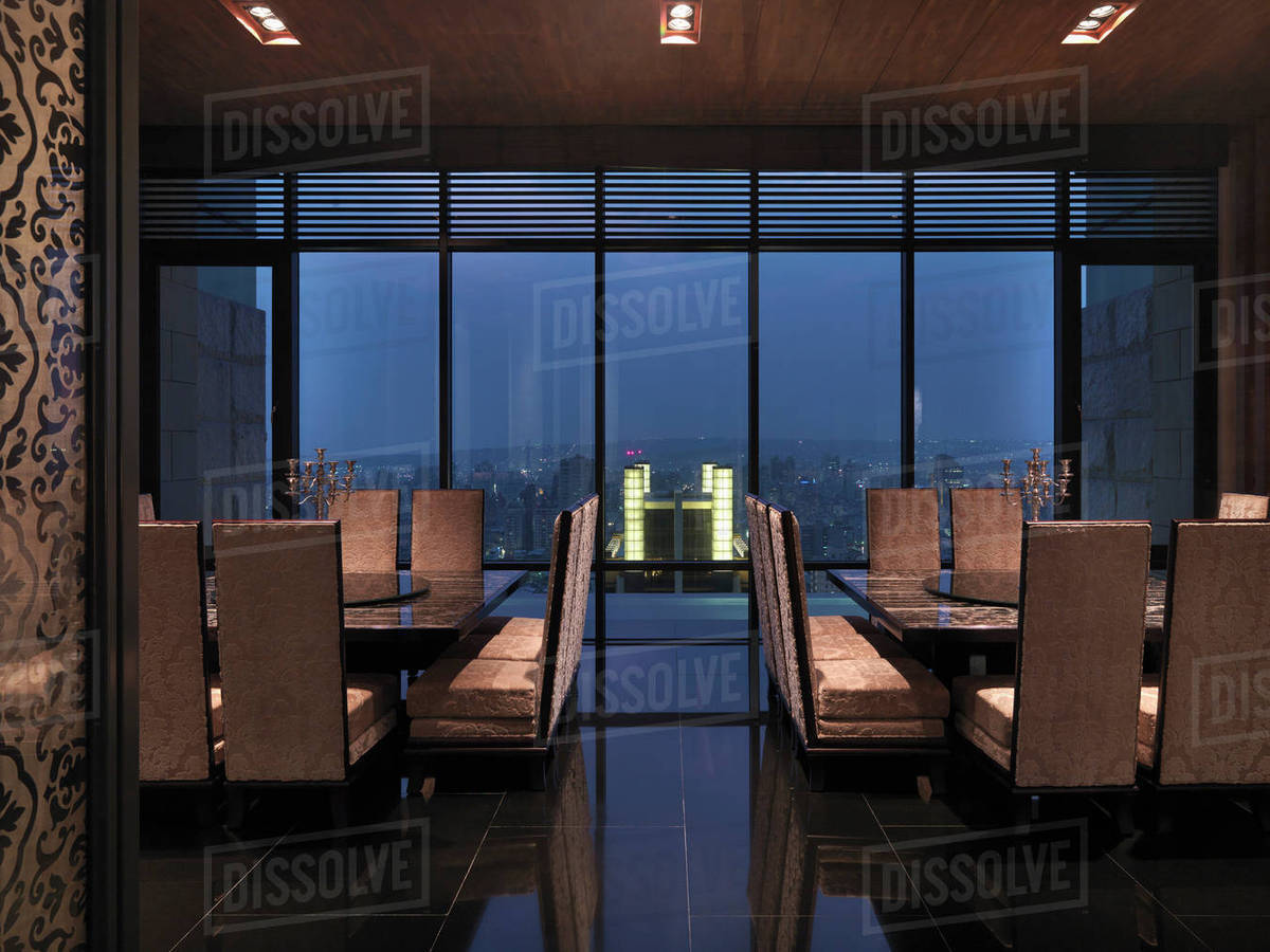 Large modern dining room overlooking city - Stock Photo - Dissolve