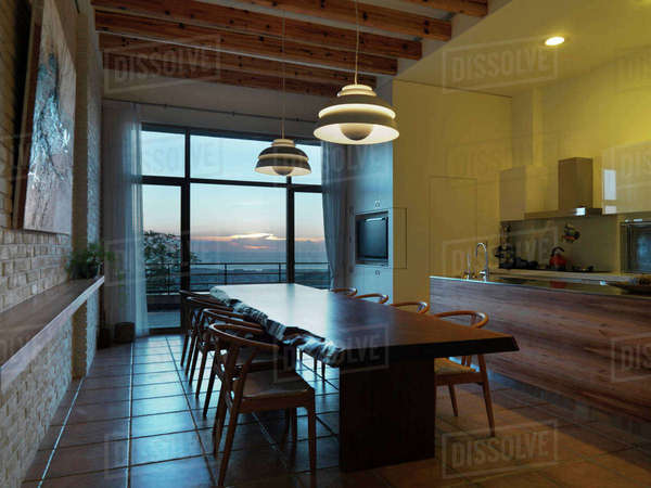 Large wooden dining table in kitchen at sunset - Royalty-free Stock ...