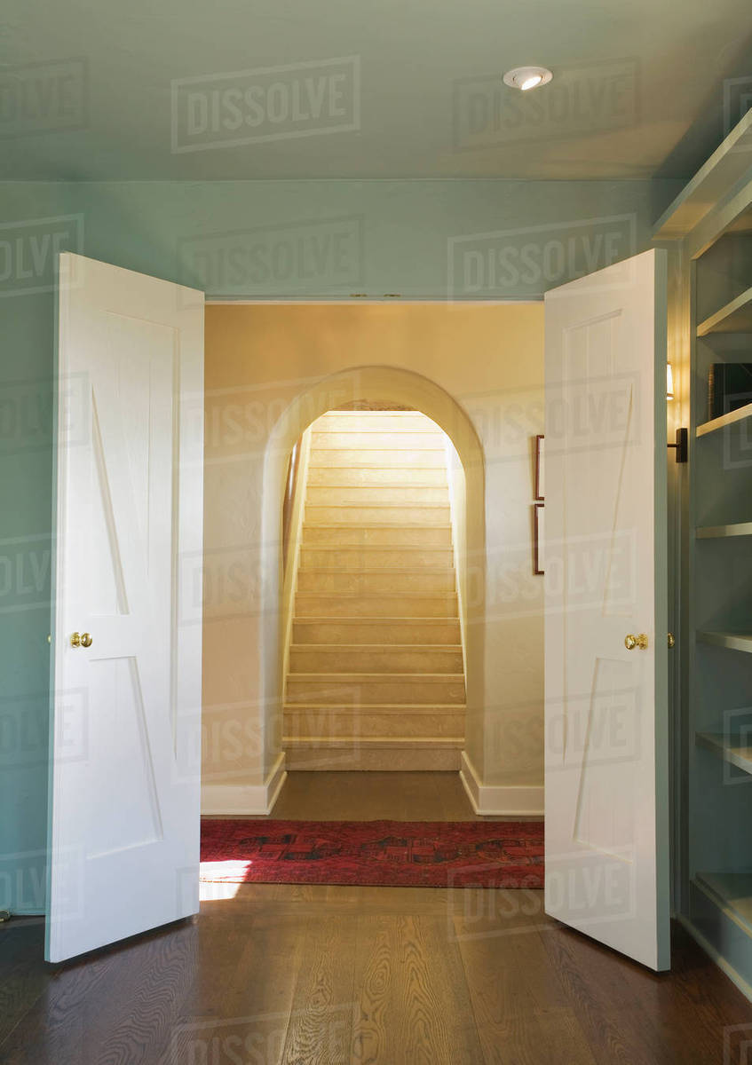 Open double doors leading to an upward staircase - Royalty-free Stock ...