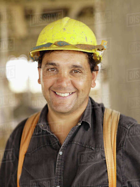 Hispanic worker smiling on construction site - Royalty-free Stock Photo ...