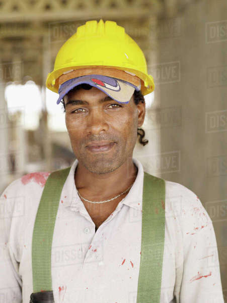 Hispanic worker smiling on construction site - Royalty-free Stock Photo ...