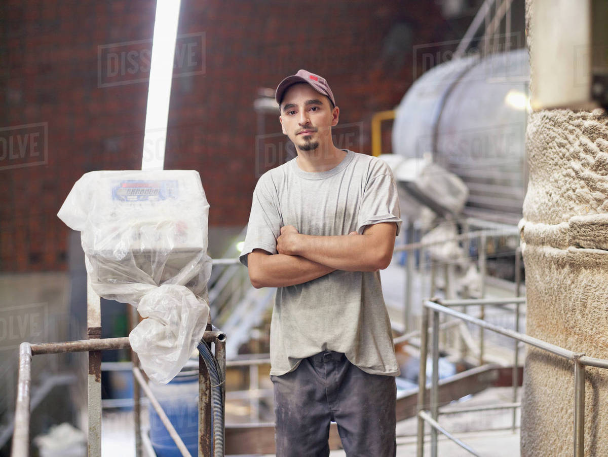 Hispanic worker in factory - Royalty-free Stock Photo | Dissolve