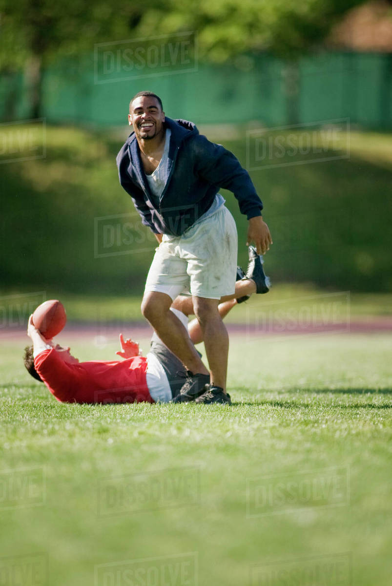 Men playing football - Royalty-free Stock Photo | Dissolve