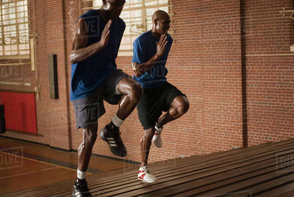 Basketball players running on bleachers - Stock Photo - Dissolve