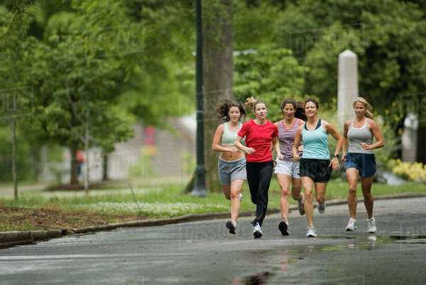 Runners jogging in park - Royalty-free Stock Photo | Dissolve