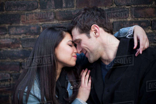 Couple hugging against wall - Royalty-free Stock Photo | Dissolve