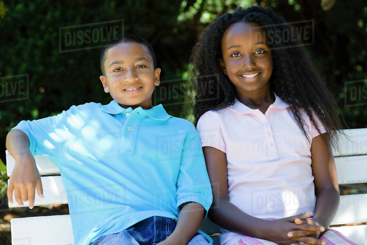 Smiling children sitting on park bench - Royalty-free Stock Photo ...