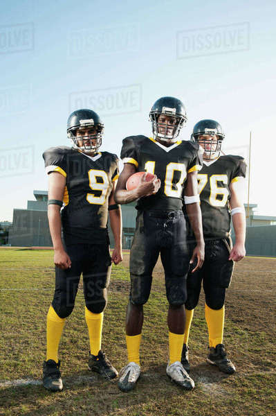 Football players standing on football field - Royalty-free Stock Photo ...