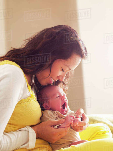 Mother holding newborn baby in her lap - Royalty-free Stock Photo ...