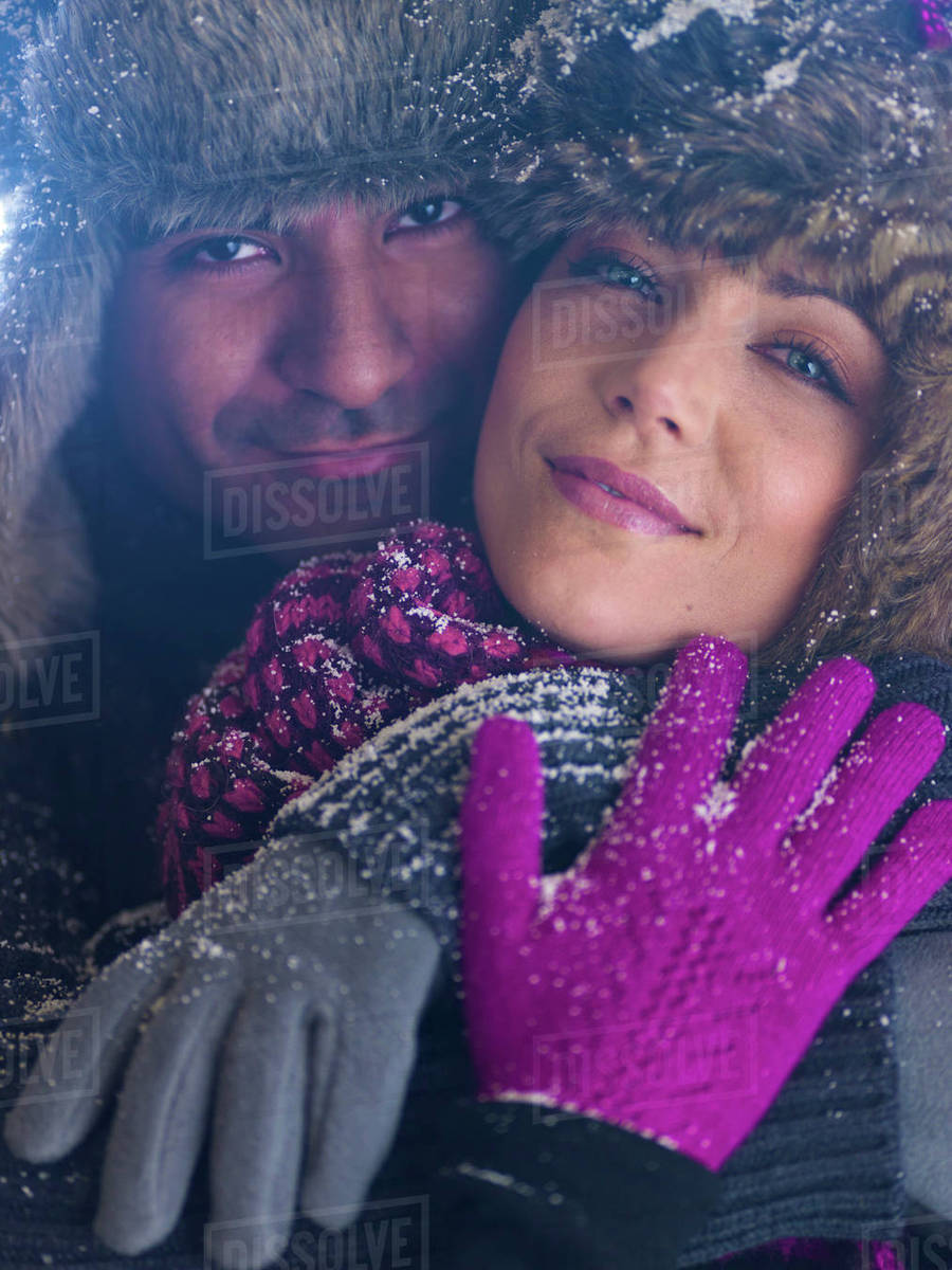 Couple in fur caps hugging - Royalty-free Stock Photo | Dissolve