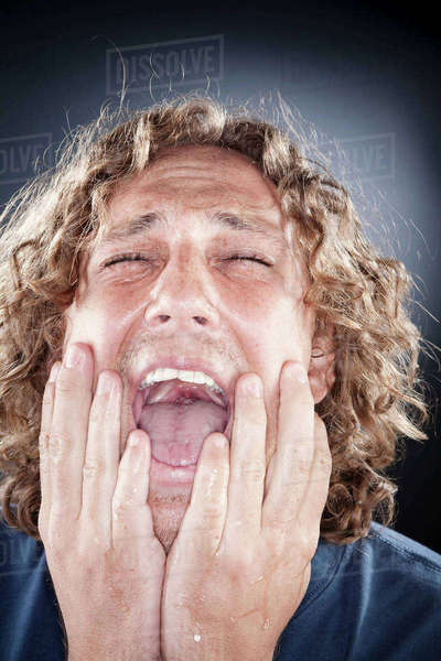 Caucasian man shouting with head in hands - Royalty-free Stock Photo ...