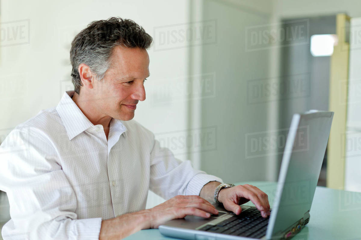 Man typing on laptop - Stock Photo - Dissolve