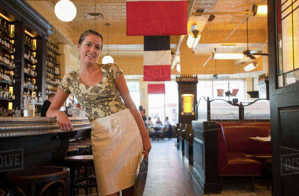 Caucasian waitress leaning on bar in restaurant - Royalty-free Stock ...