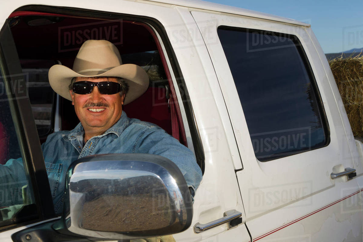 Hispanic man driving truck - Royalty-free Stock Photo | Dissolve