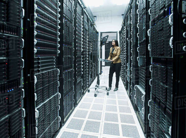 Business people working in server room - Stock Photo - Dissolve
