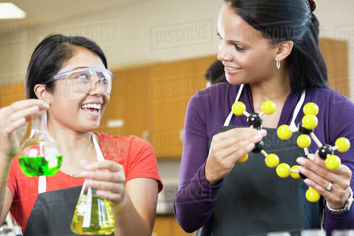 Teacher and student working with chemicals in classroom - Royalty-free ...
