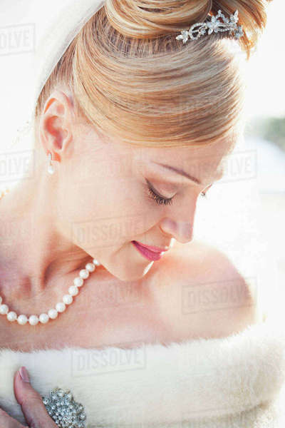 Hispanic bride looking down - Royalty-free Stock Photo | Dissolve