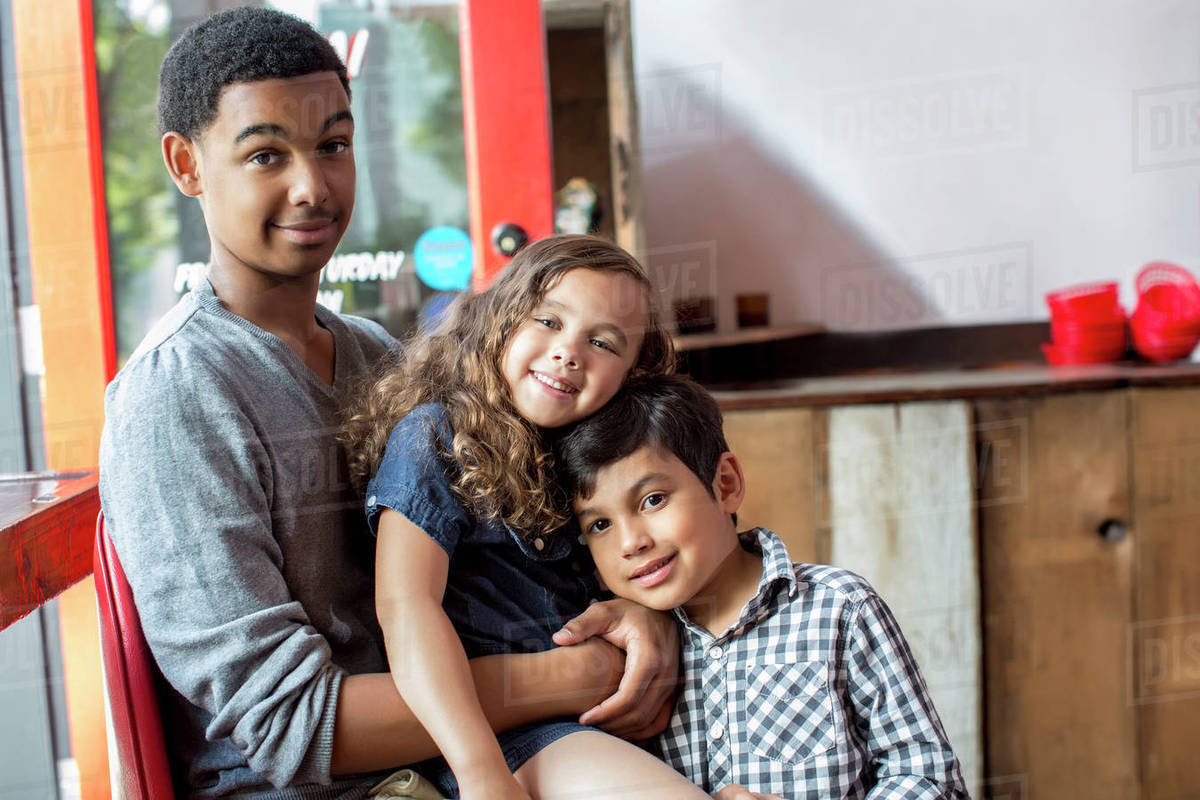 Mixed race brothers and sister smiling together - Royalty-free Stock ...