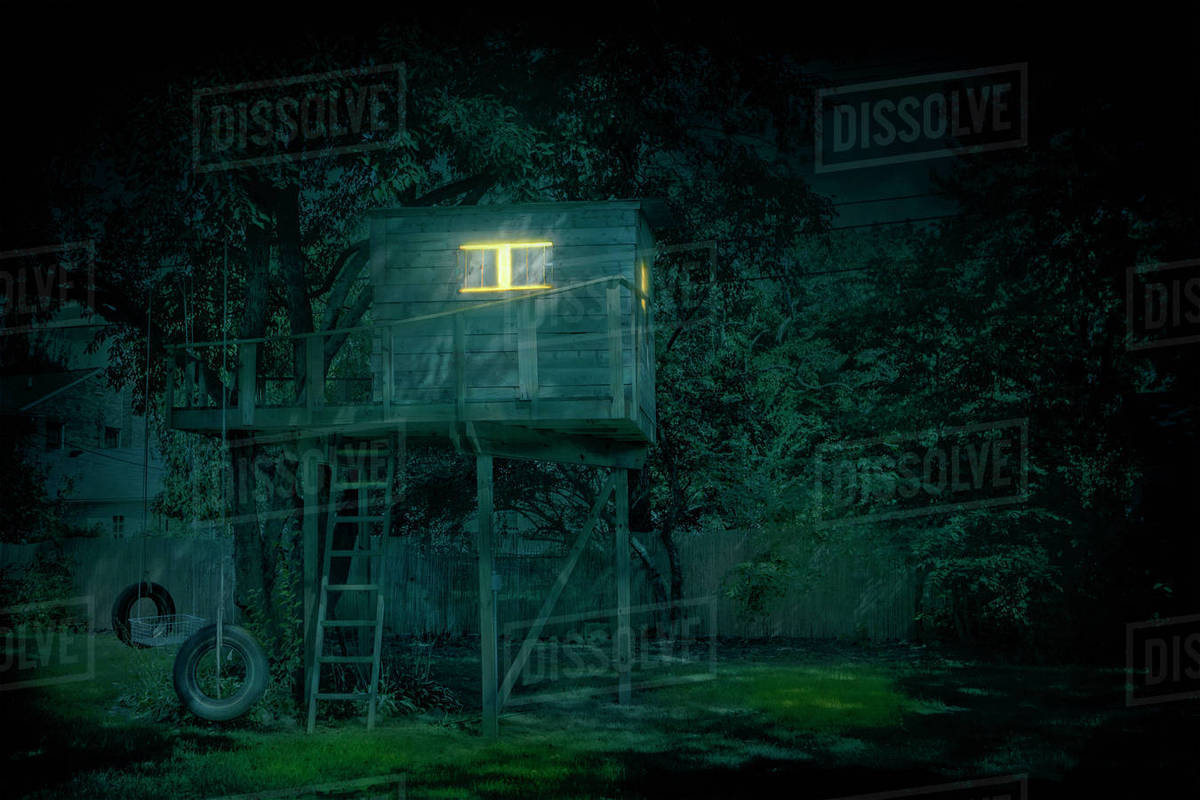 Illuminated treehouse in backyard at night - Royalty-free Stock Photo ...