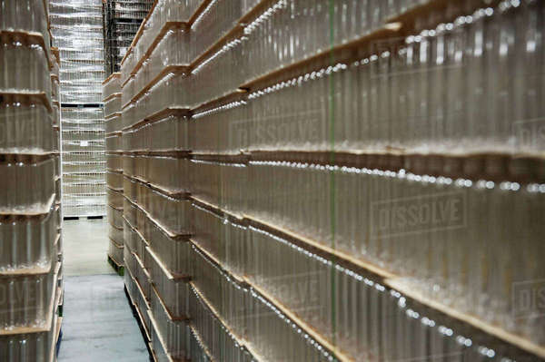 Glass bottles stacked in warehouse - Stock Photo - Dissolve