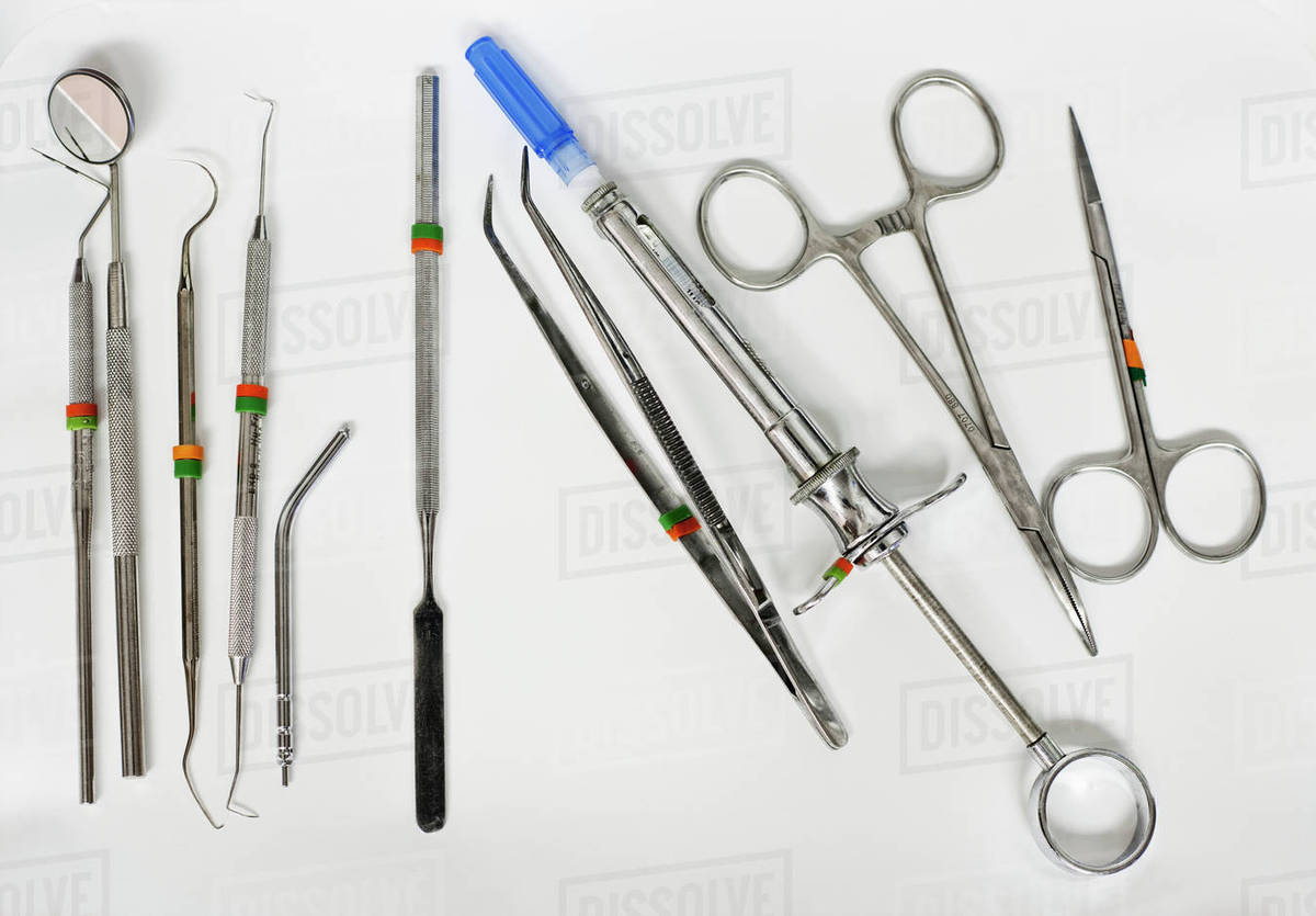 Dental Instruments on White Surface - Stock Photo - Dissolve