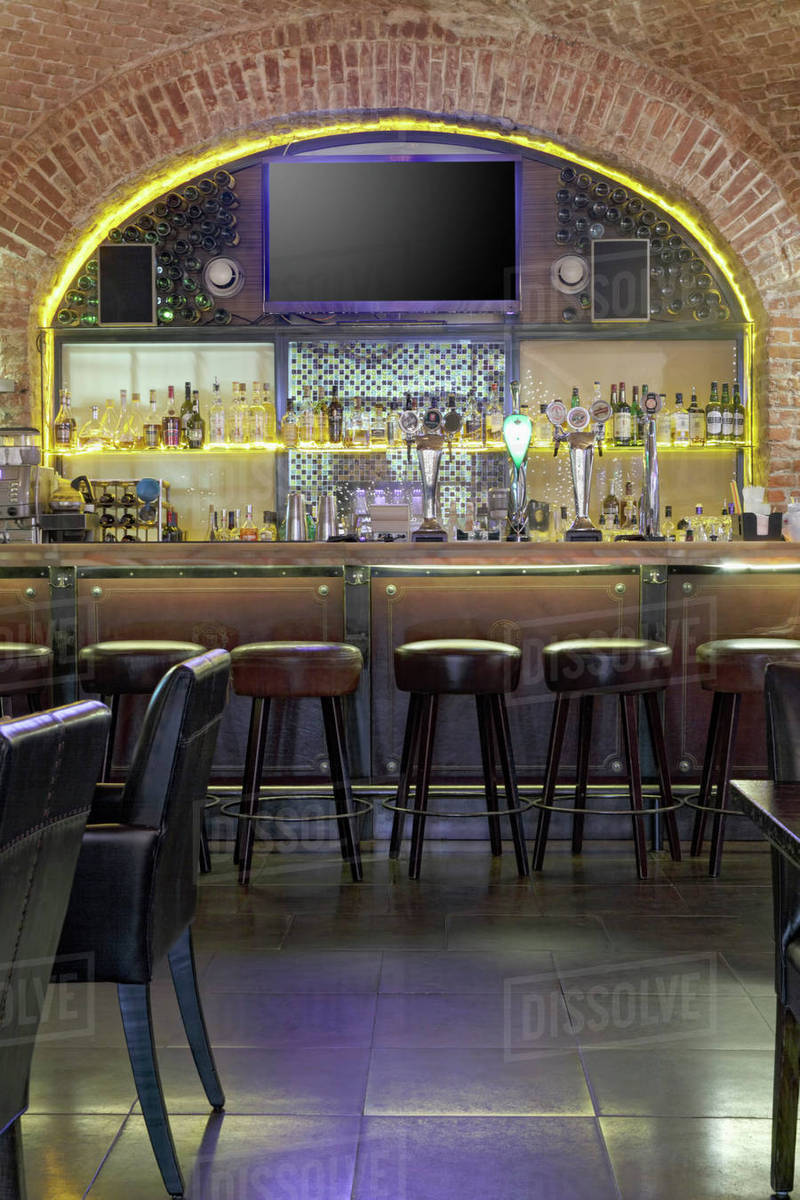 Bar with big TV screen on wall - Stock Photo - Dissolve