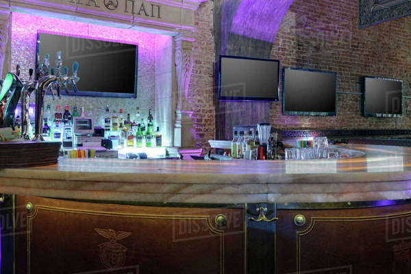 TV screens in a row against bar stand - Stock Photo - Dissolve