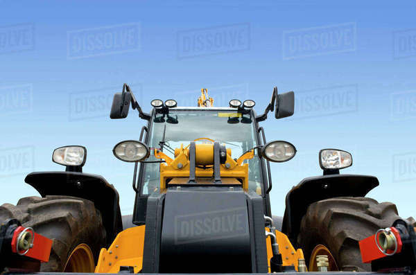 A frontal view of a spotless modern digger - Stock Photo - Dissolve