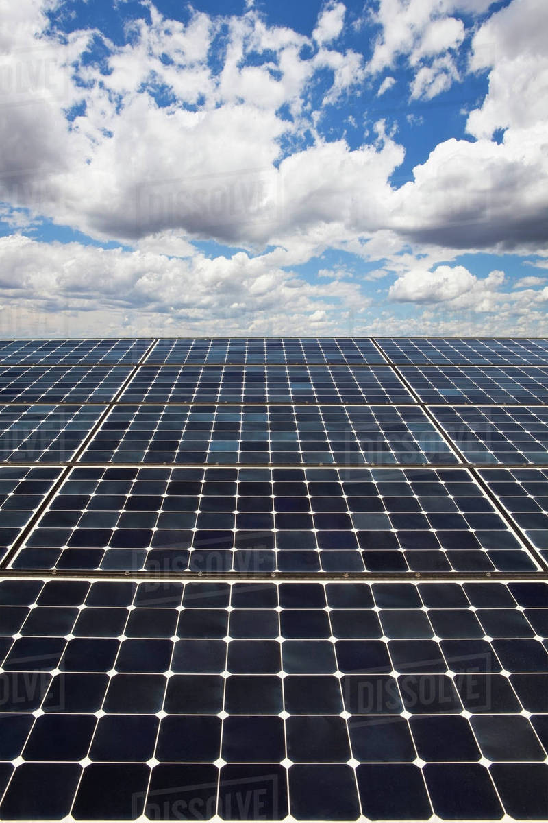 Blue sky and clouds over solar panels - Royalty-free Stock Photo | Dissolve