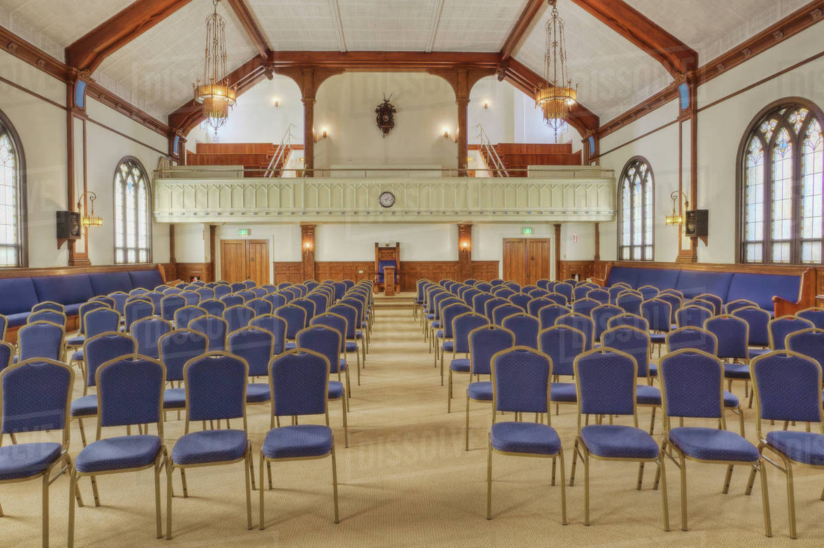 Auditorium with blue chairs, and a stage with curtains - Royalty-free ...