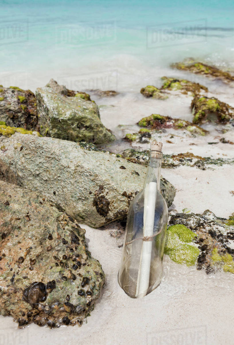 Note in bottle washed up on shore - Stock Photo - Dissolve