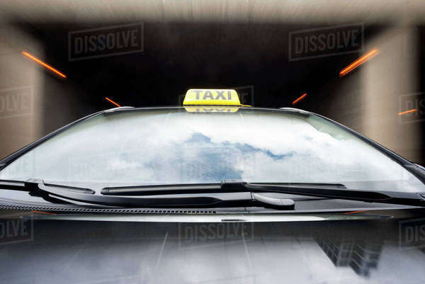 Taxi cab emerging from a tunnel - Stock Photo - Dissolve